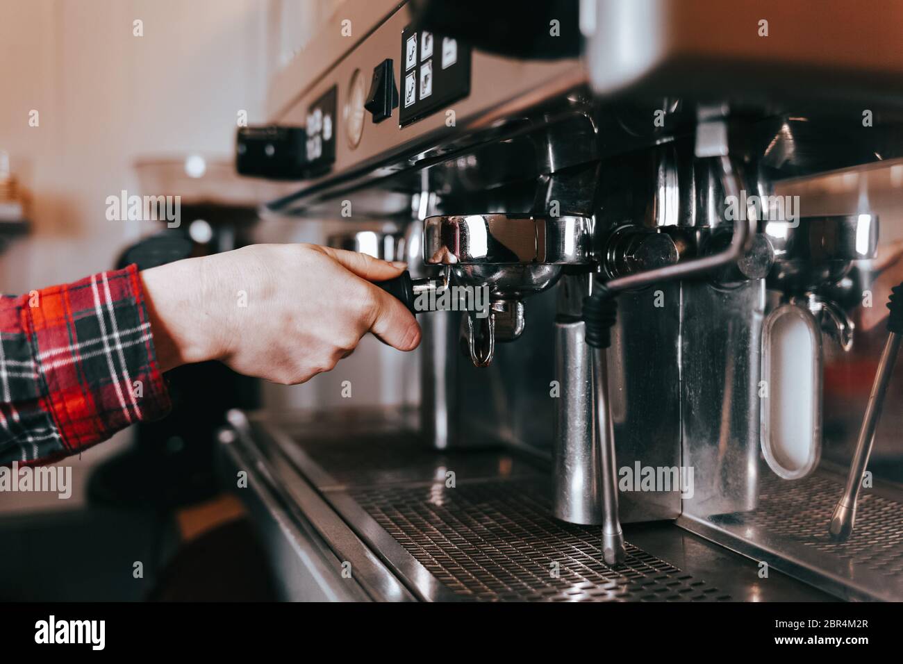 Barista makes aromatic coffee. Process of making latte coffee on a ...
