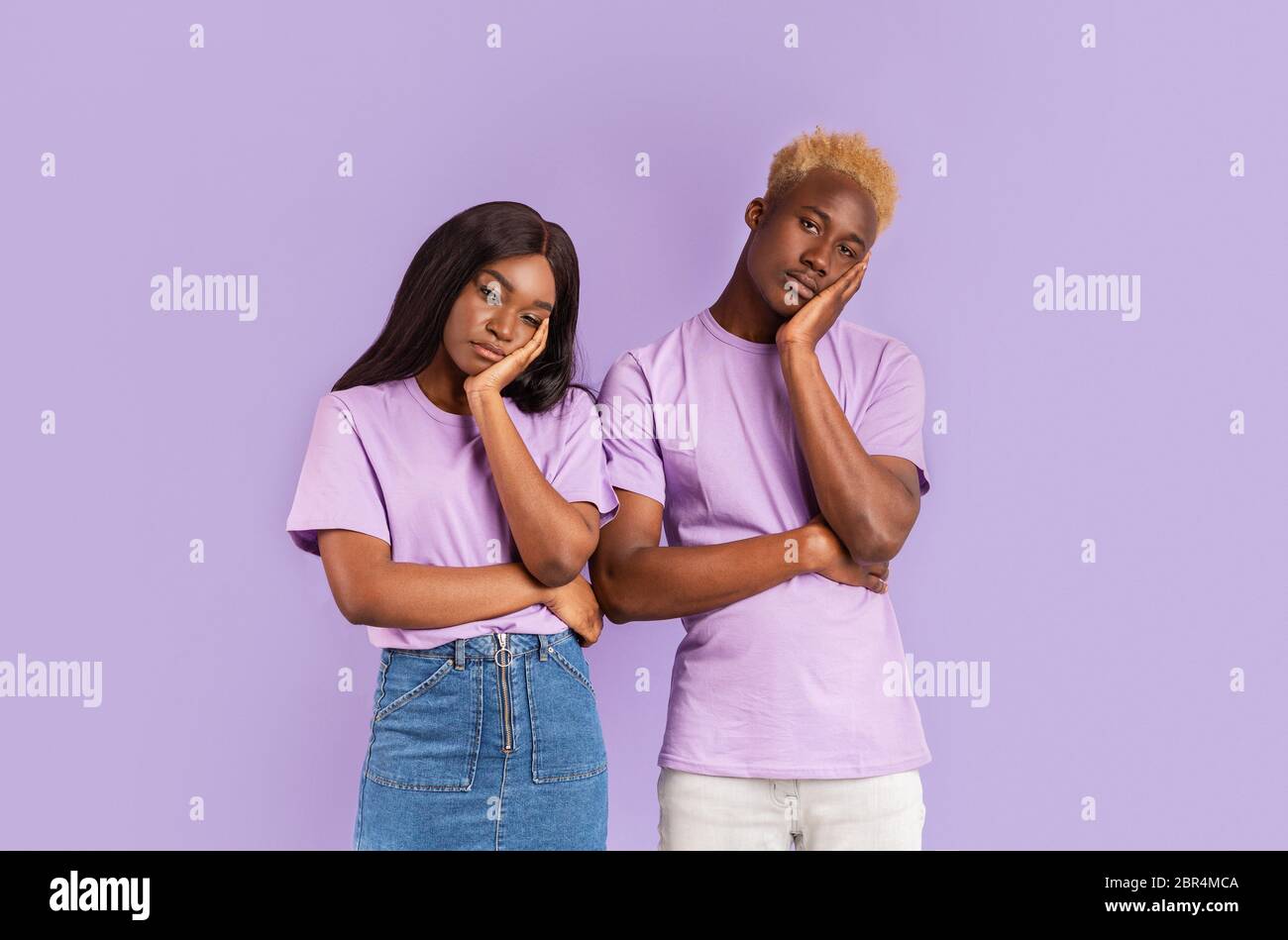 Bored African American couple with dull facial expressions on color ...