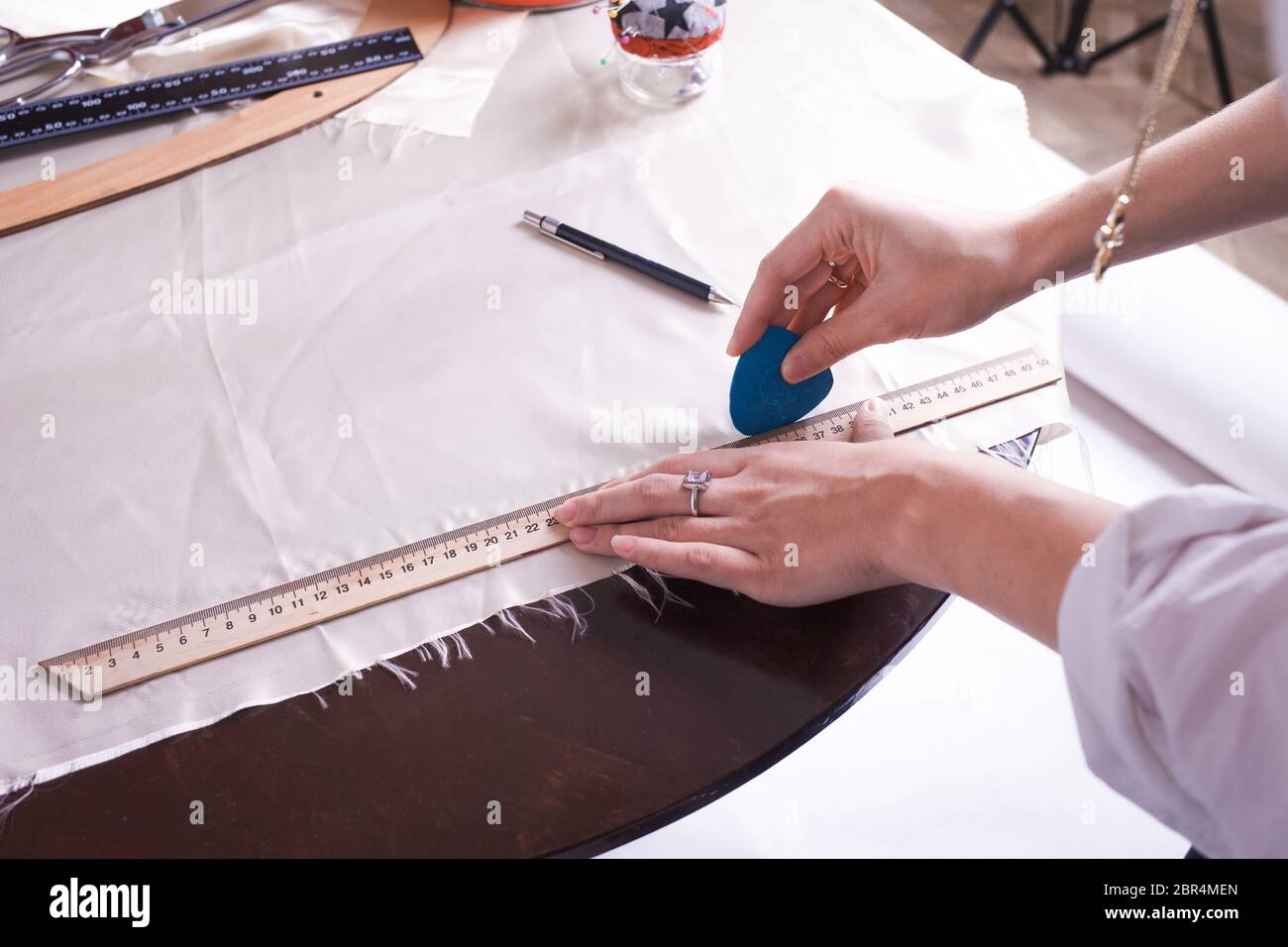 The seamstress makes a pattern for the future product. Sewing workshop ...