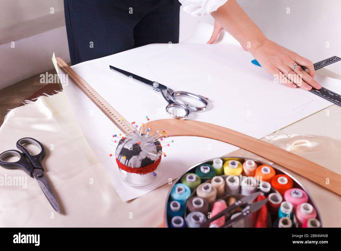 The seamstress makes a pattern for the future product. Sewing workshop ...