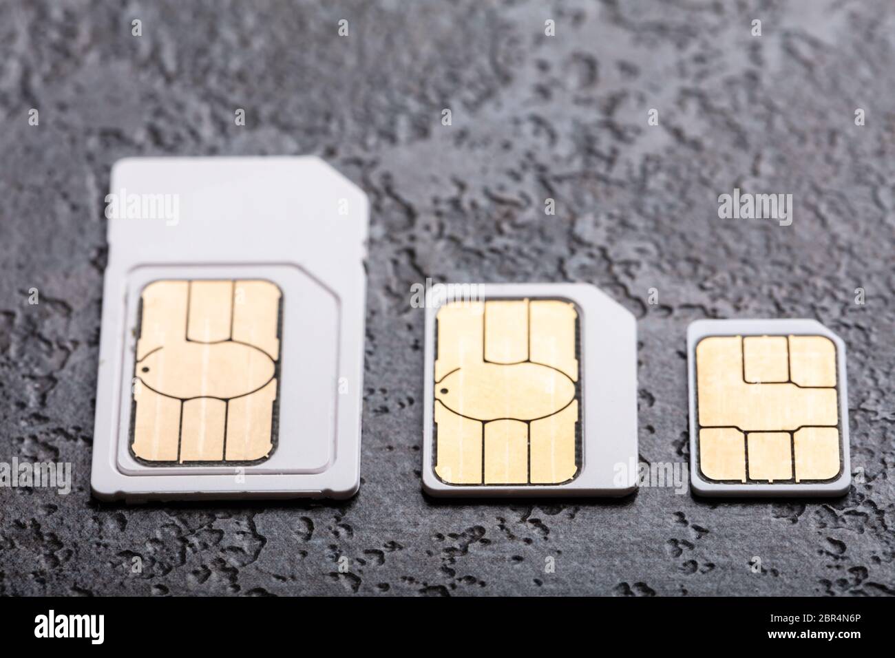 Three Types Of Sim Cards Arranged In A Row Over Concrete Gray ...