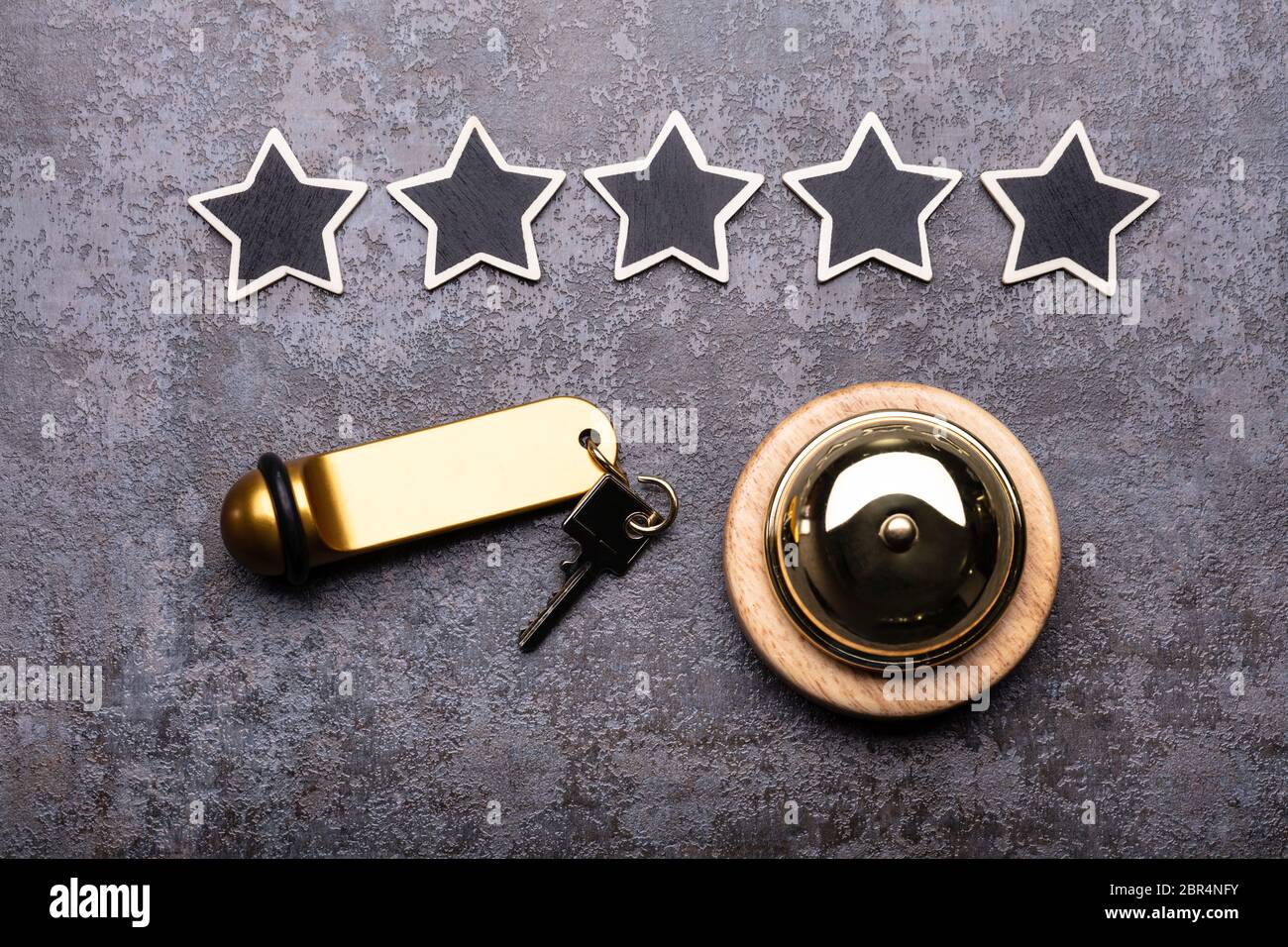 Service Bell And Hotel Key On Black Background Stock Photo - Alamy