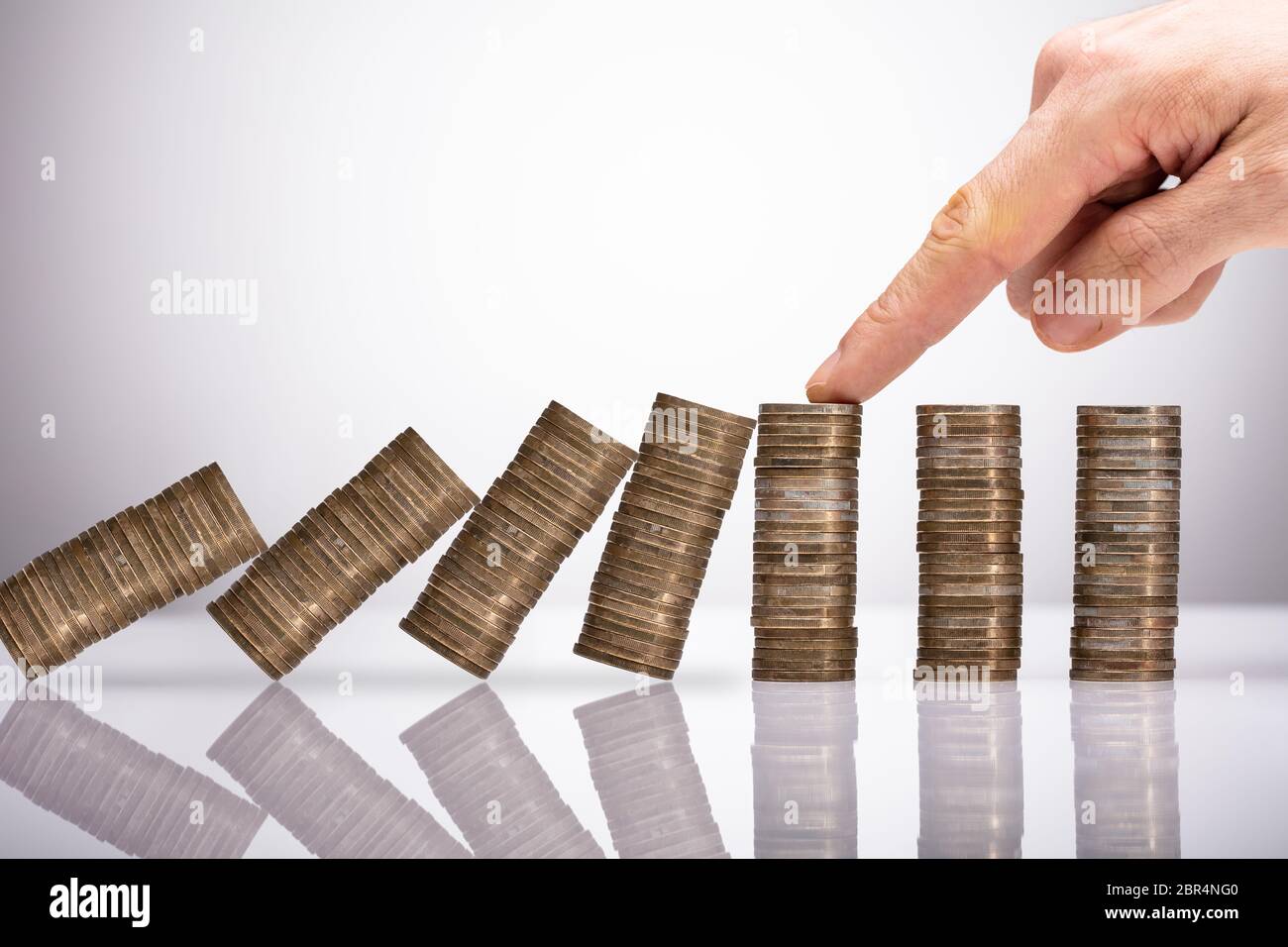 Close-up Of A Businessperson's Hand Protecting Stacked Coins From ...