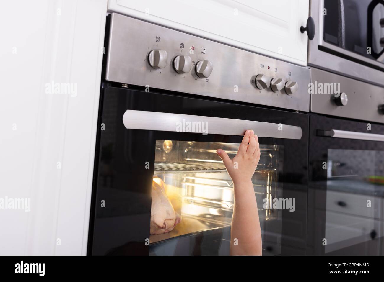 Little Girl Playing With Electric Microwave Oven In The Kitchen Stock ...