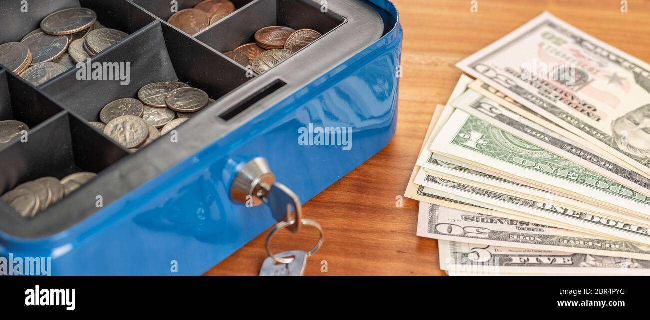 A cash box with bills and coins Stock Photo - Alamy