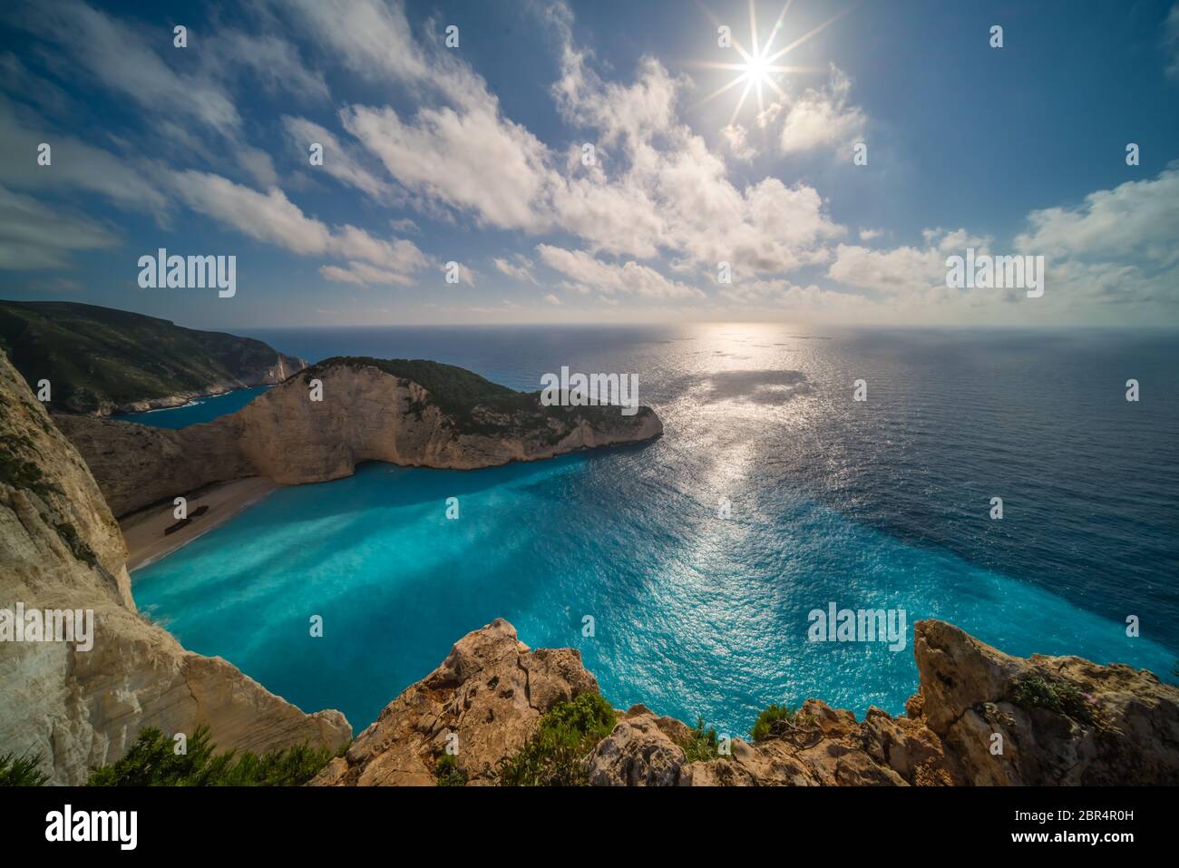View of the sun shining over cliffs in Shipwreck Cove in summer on ...