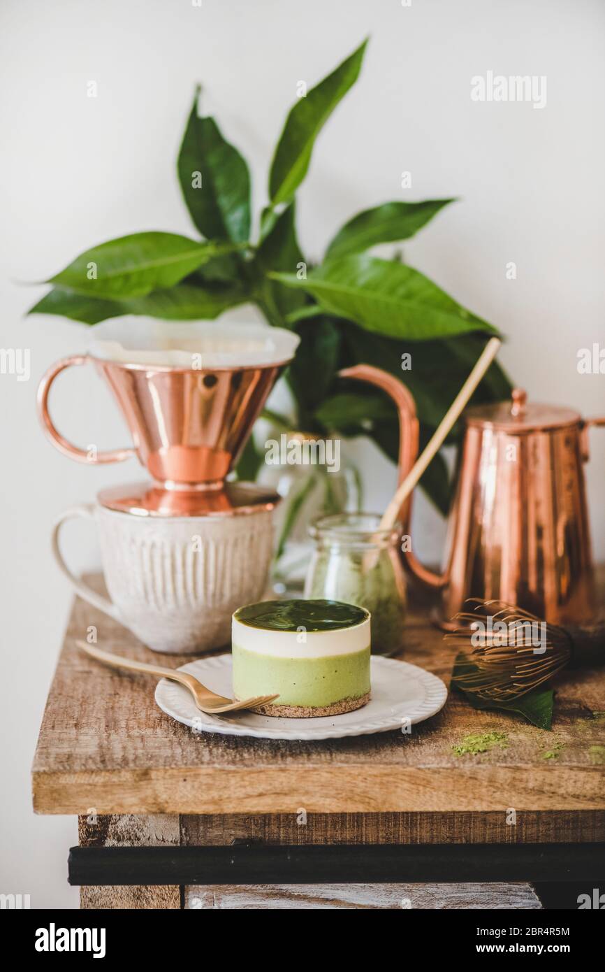 Coffee and dessert setup. Green matcha cheesecake and brewed black ...