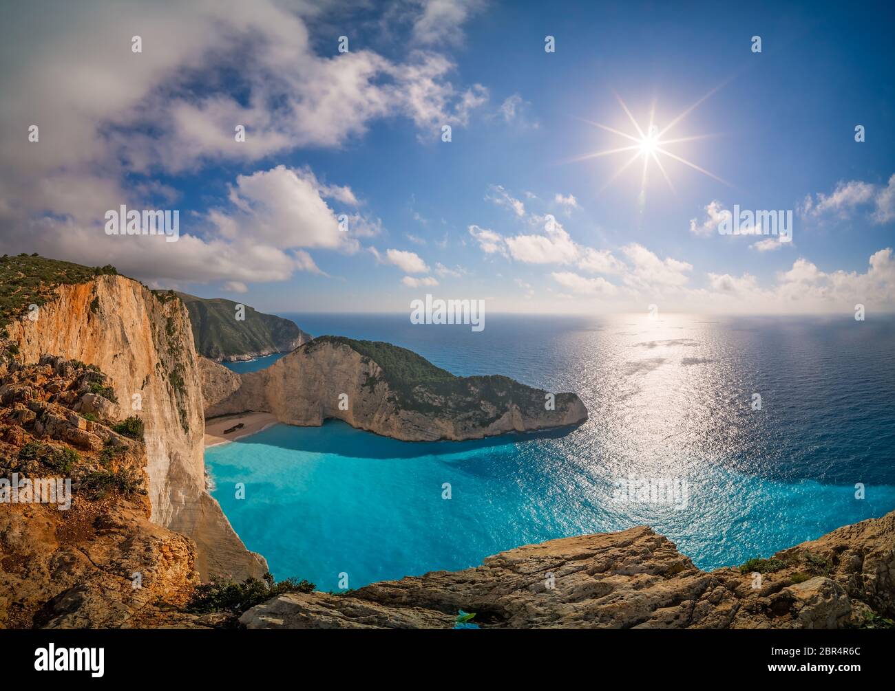 View of the sun shining over cliffs in Shipwreck Cove in summer on ...