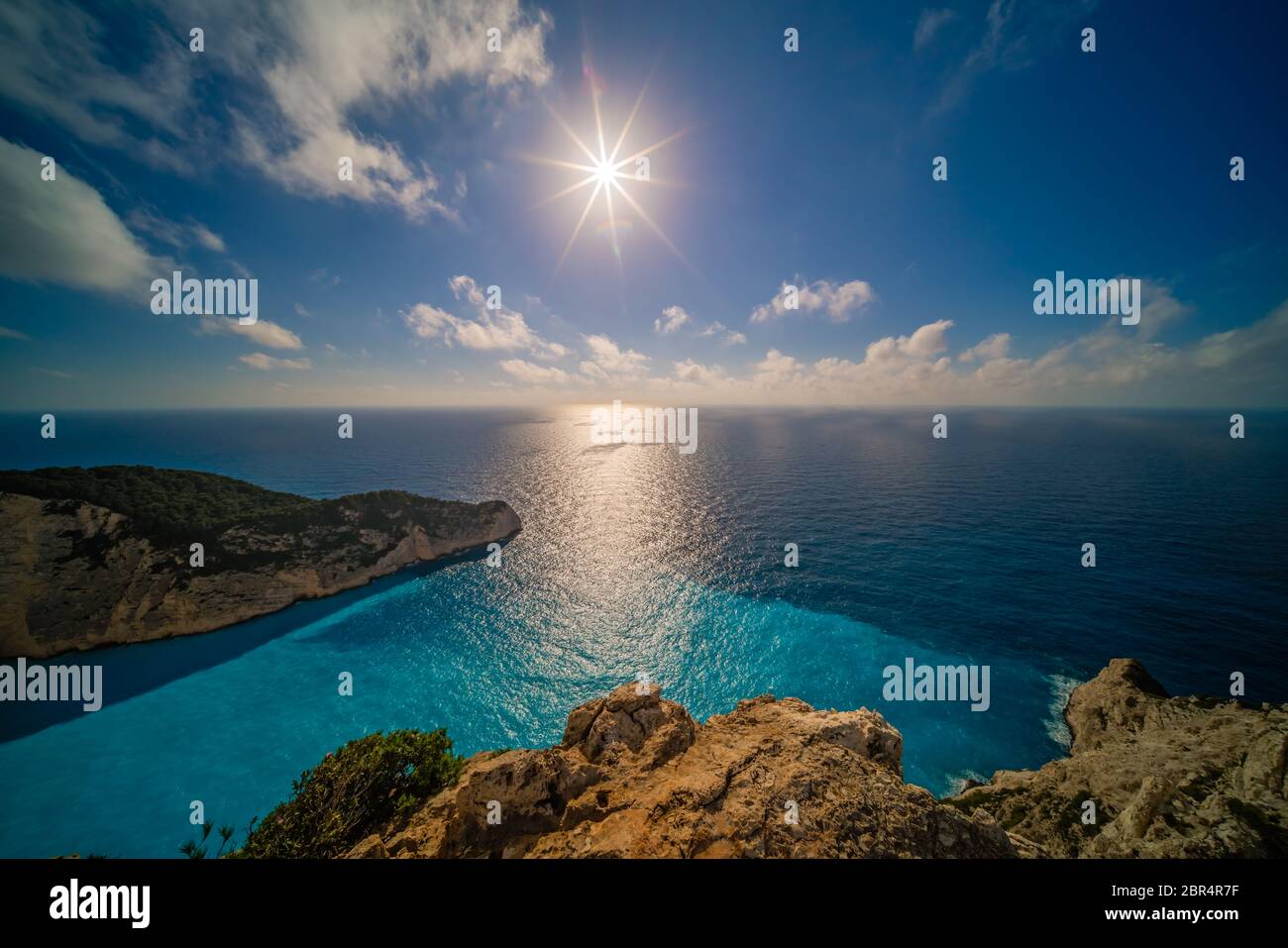 View of the sun shining over cliffs in Shipwreck Cove in summer on ...