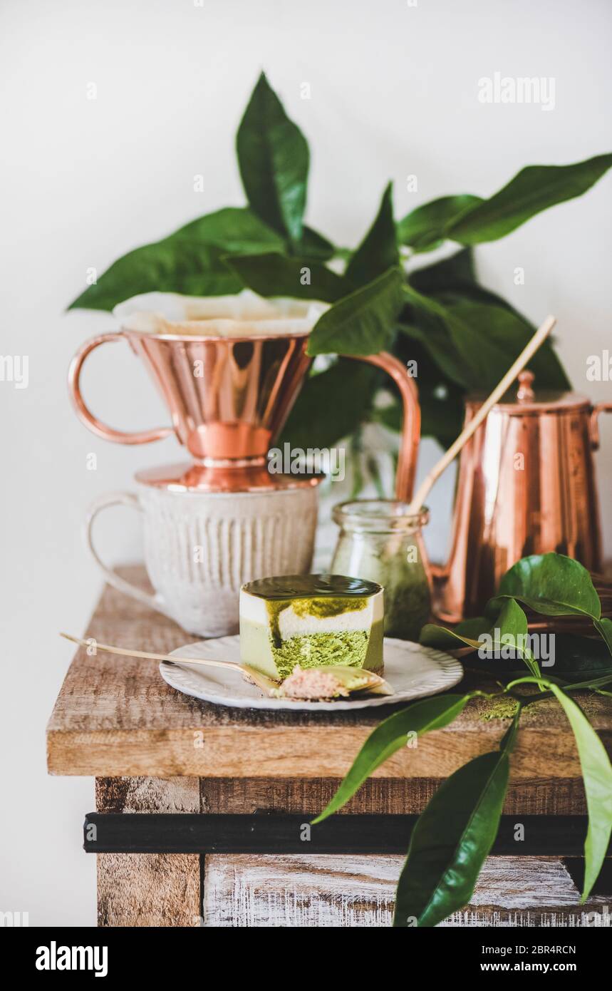 Coffee and dessert setup. Green matcha cheesecake and brewed coffee in ...