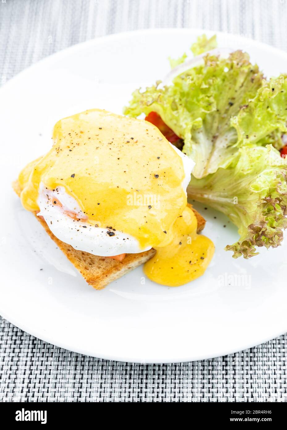 gourmet Salmon egg benedict in white plate Stock Photo - Alamy
