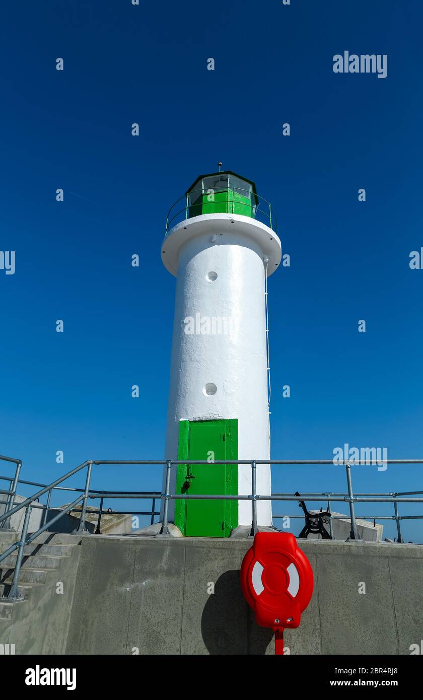 White lighthouse tower on blue sky background, Ventspils, Latvia Stock ...
