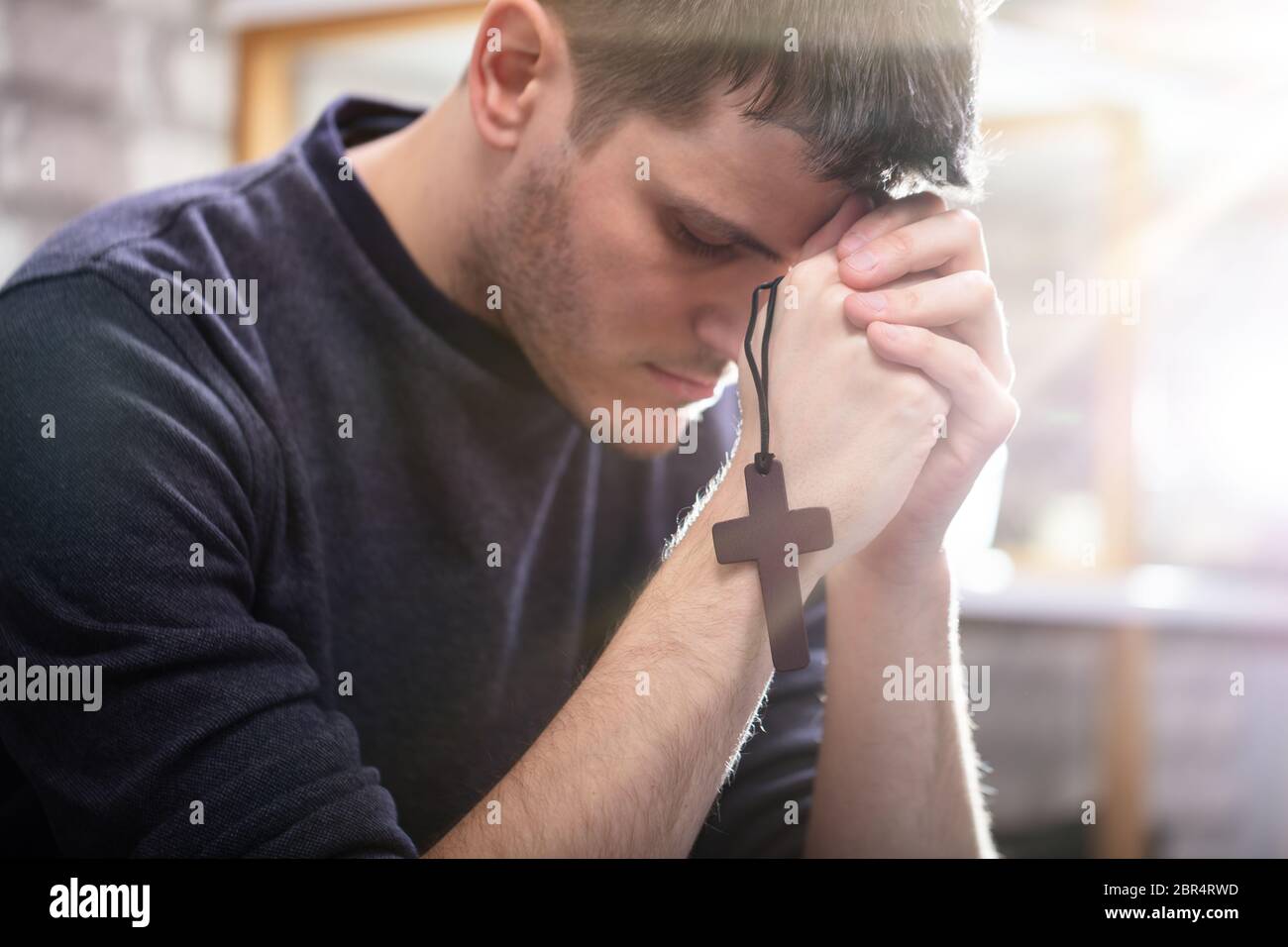 Side View Of Religious Young Man With Rosary Praying To God At Home ...