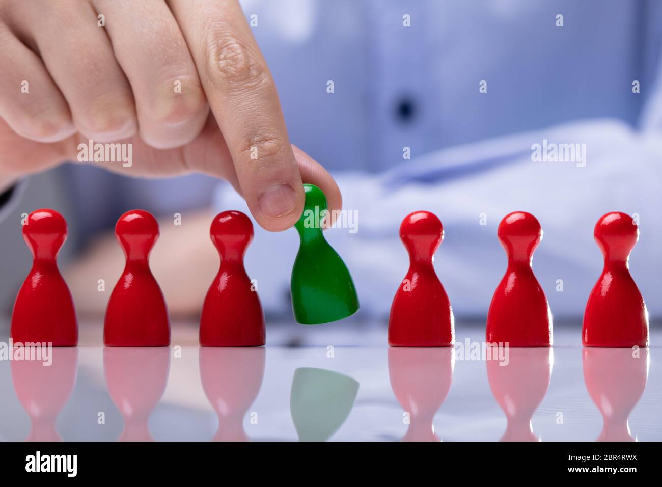 Close-up Of A Person Picking Green Figure From The Row Over The ...
