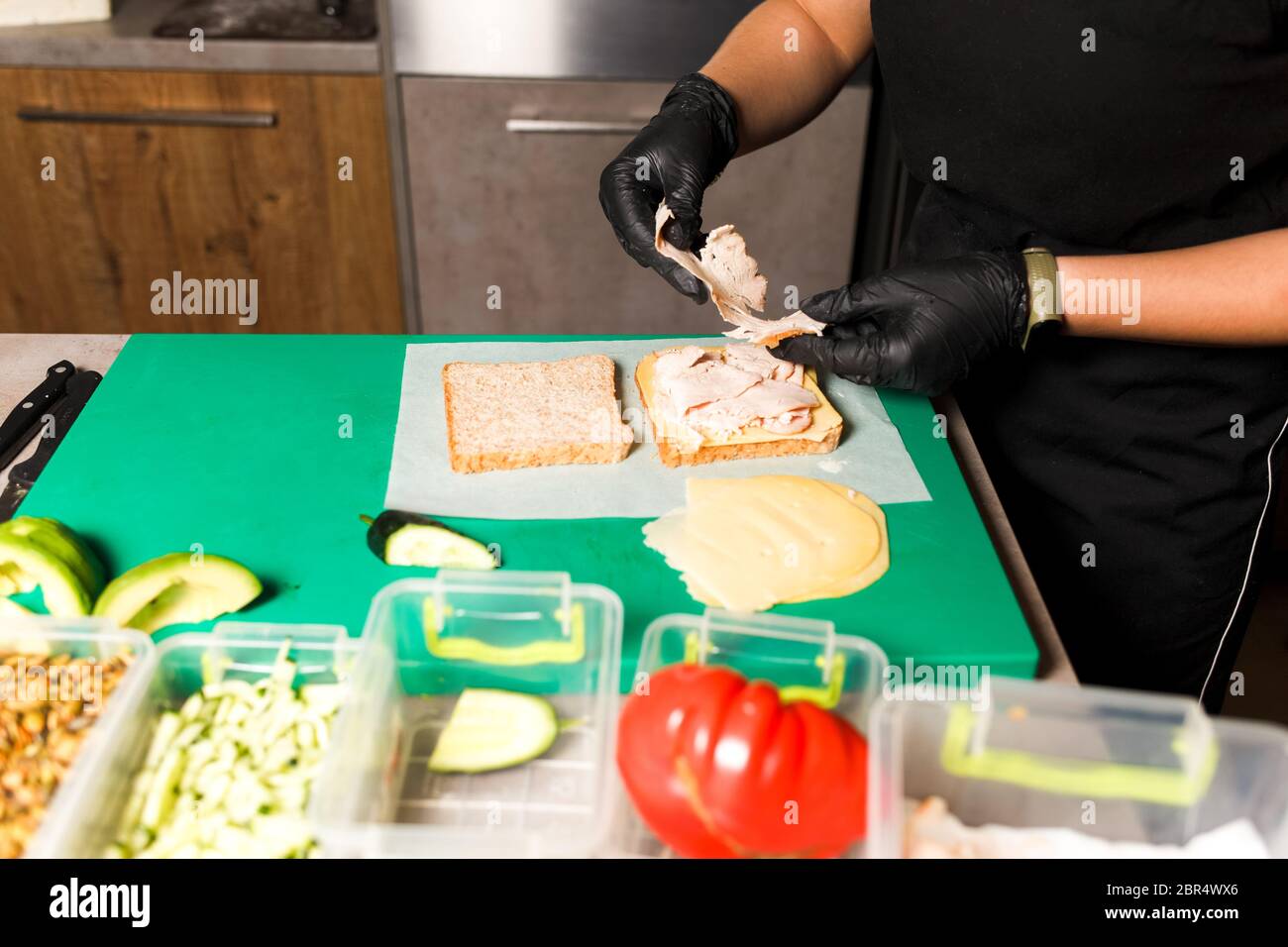 Process of making toast with ham and cheese in a restaurant kitchen ...