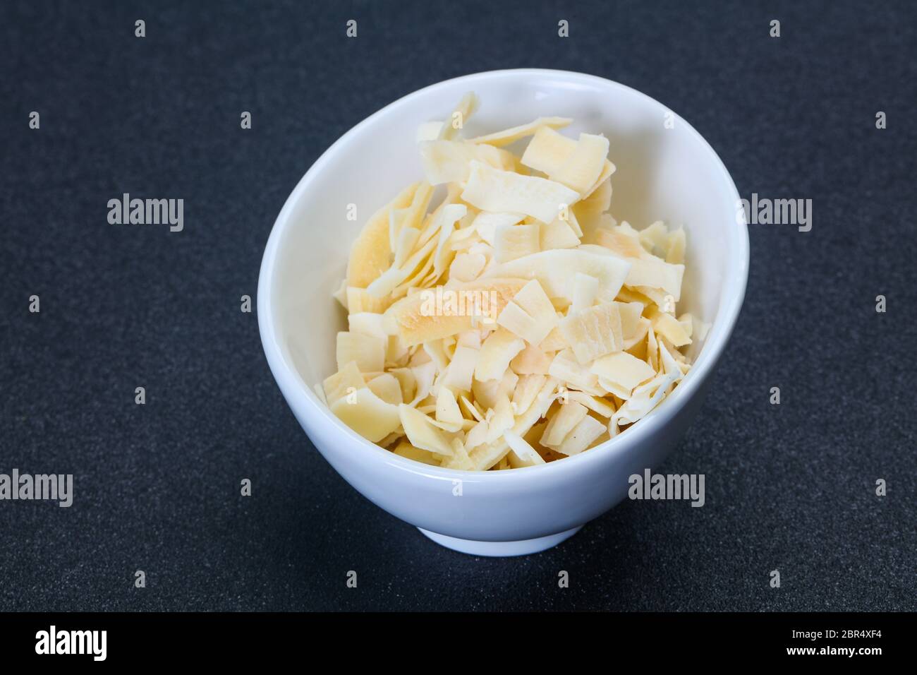 Coconut dry chips snack in the bowl Stock Photo - Alamy