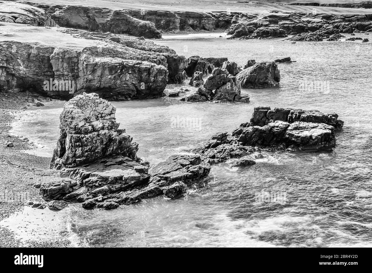 Black rocky coast with overgrown rocks hi-res stock photography and ...