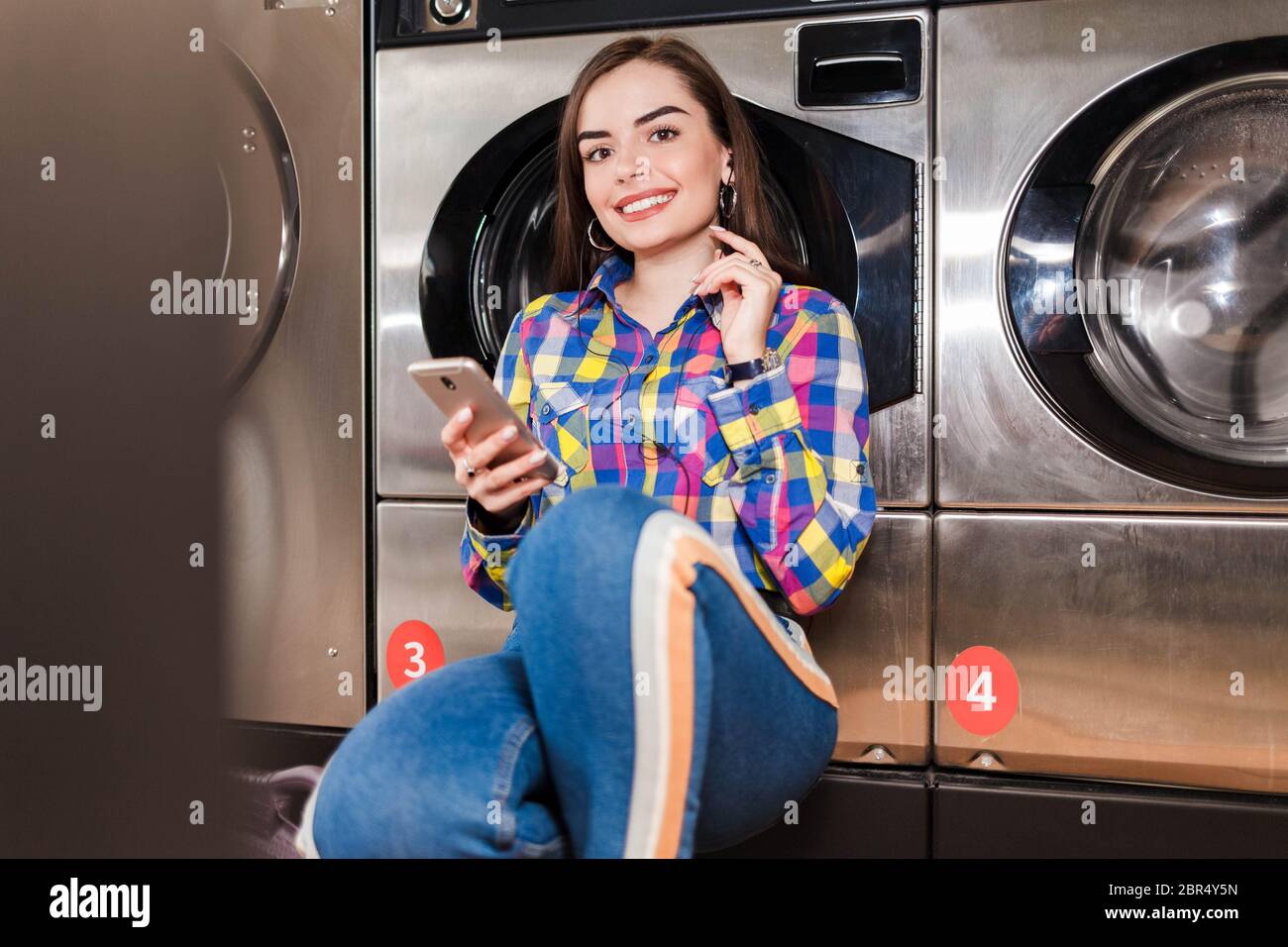 Girl sitting on washing machine hi-res stock photography and images - Alamy