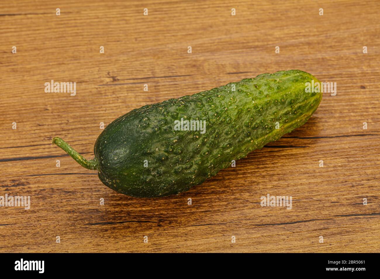 Green ripe fresh one cucumber over background Stock Photo - Alamy