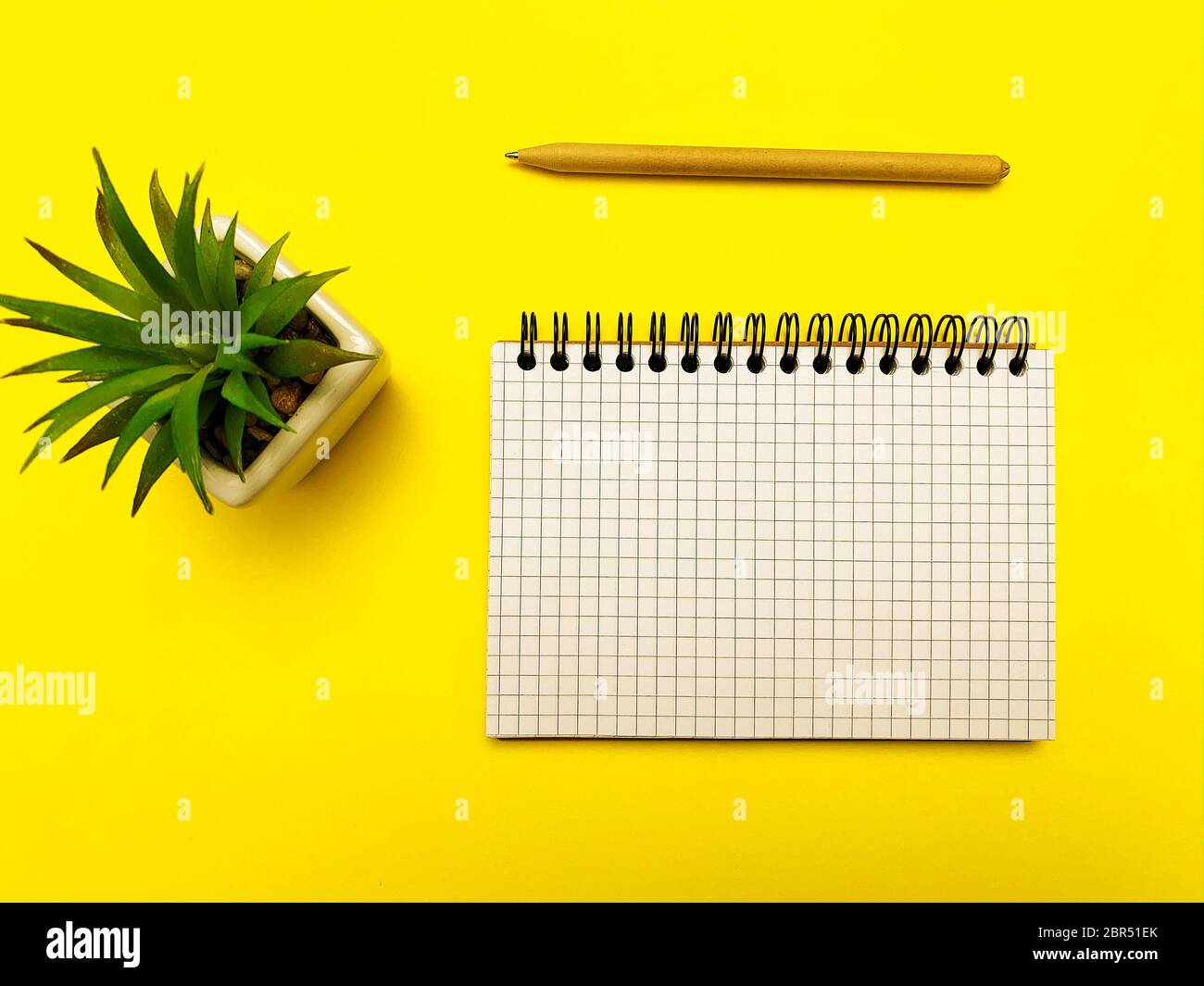 Notepad for writing on a yellow background Stock Photo - Alamy