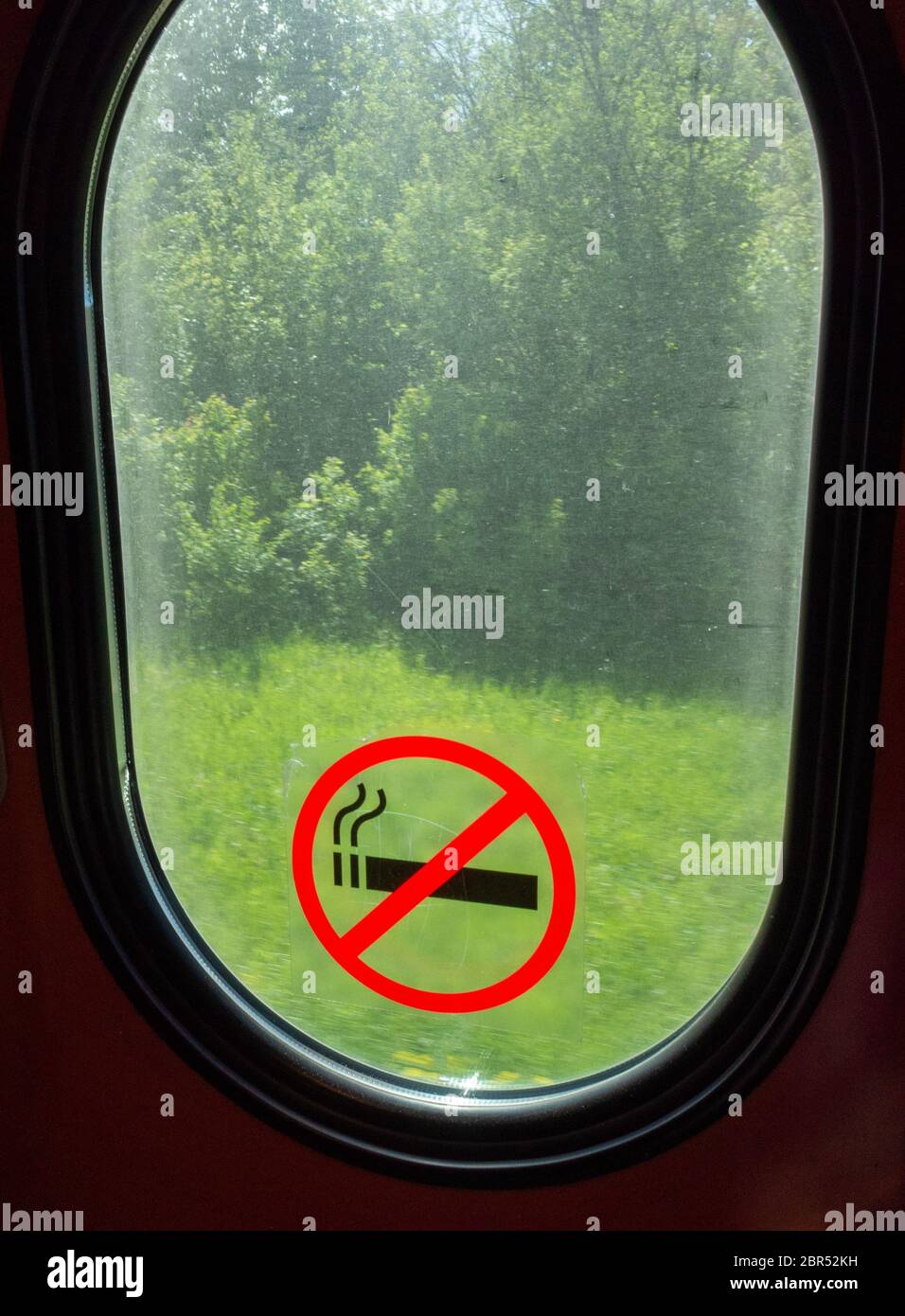 Sign "Smoking is prohibited" on the window of the vestibule of a long ...