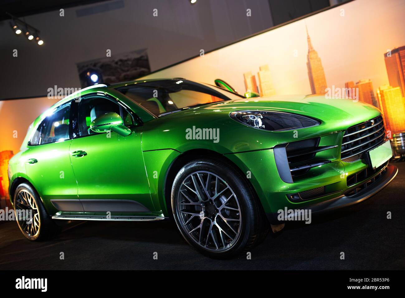 Green car on the street of a big city Stock Photo - Alamy