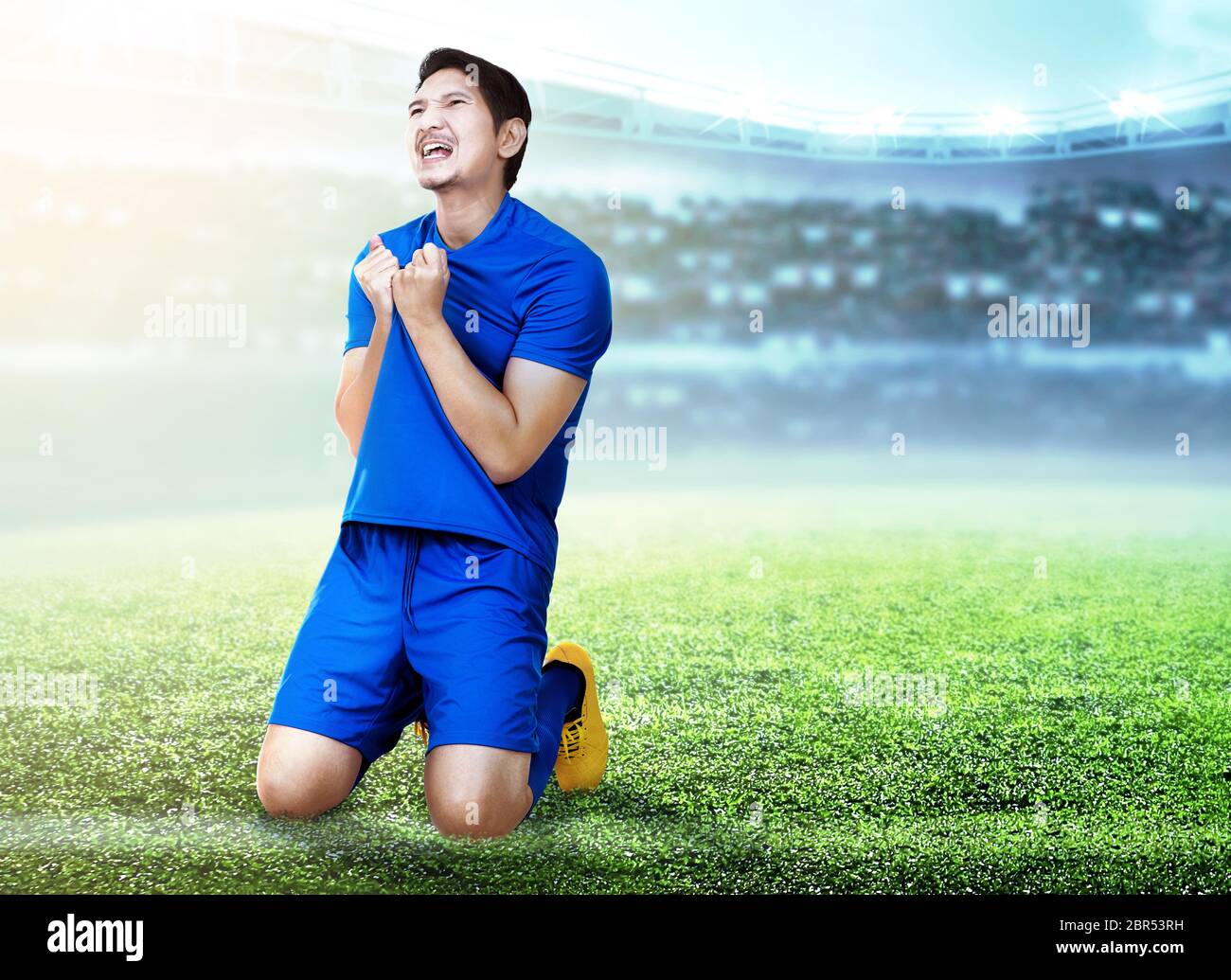 Young athlete kneeling sports field hi-res stock photography and images ...