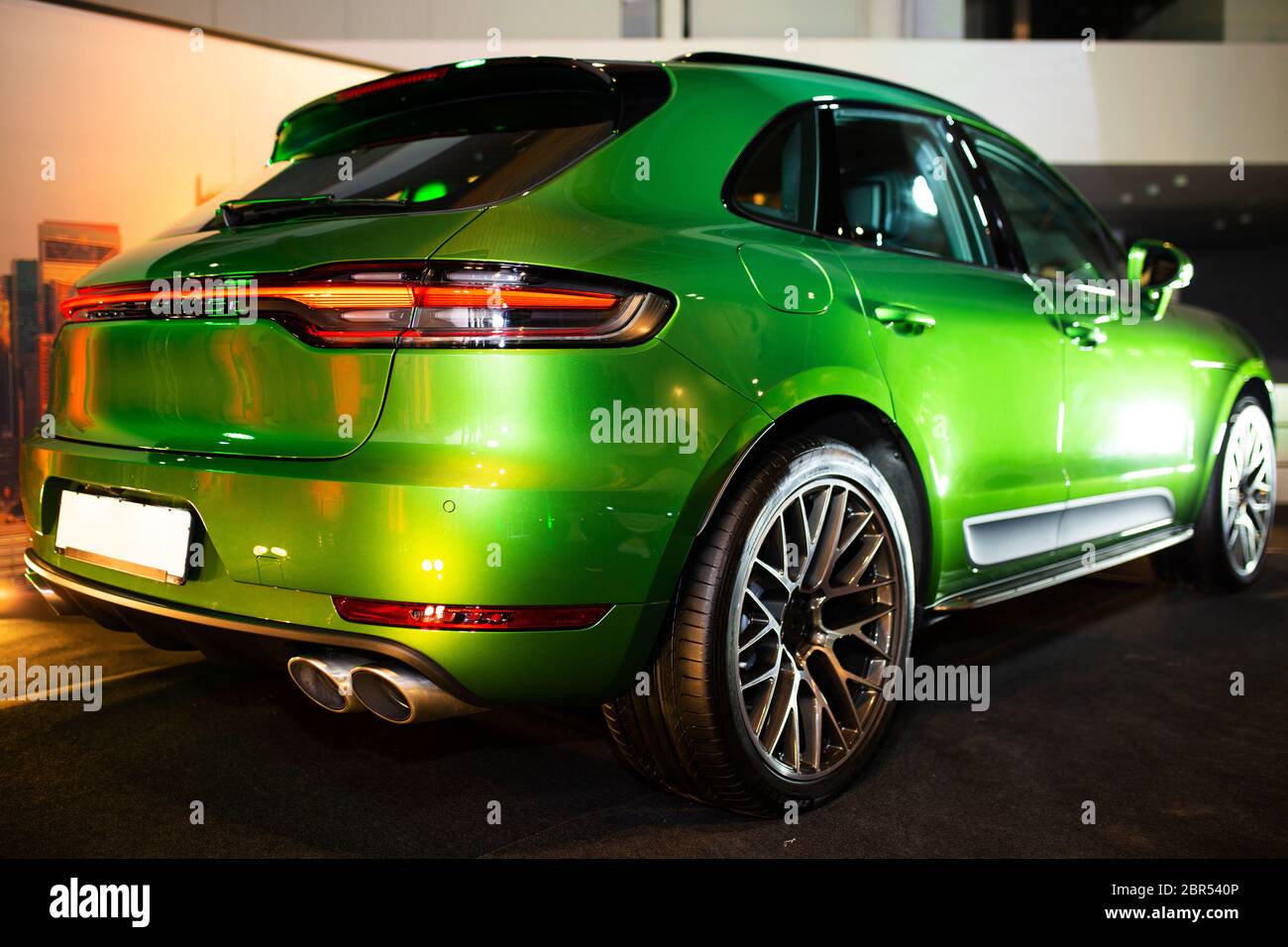Green car on the street of a big city Stock Photo - Alamy
