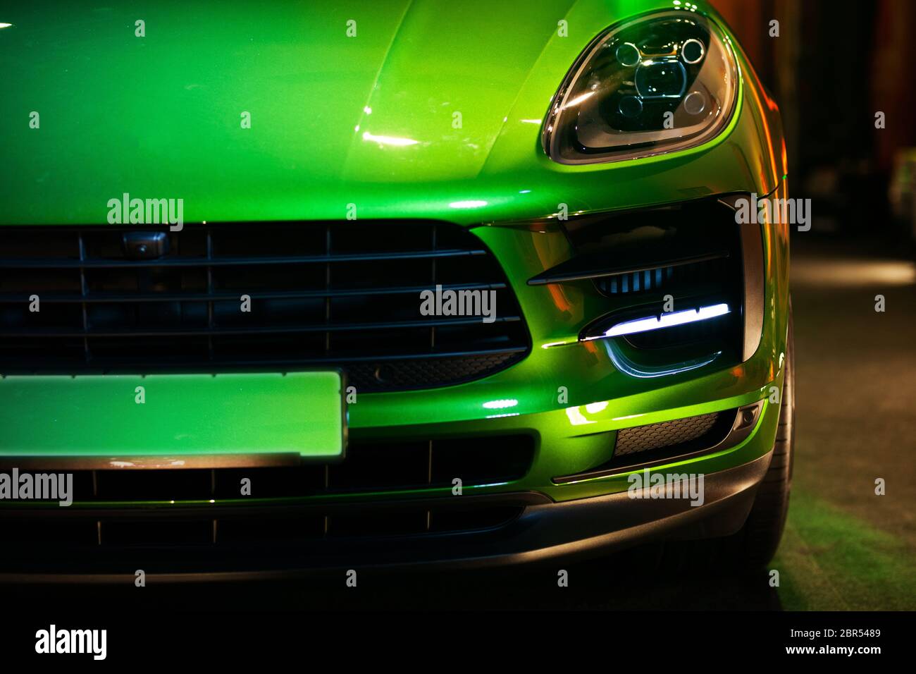 Green car on the street of a big city Stock Photo - Alamy
