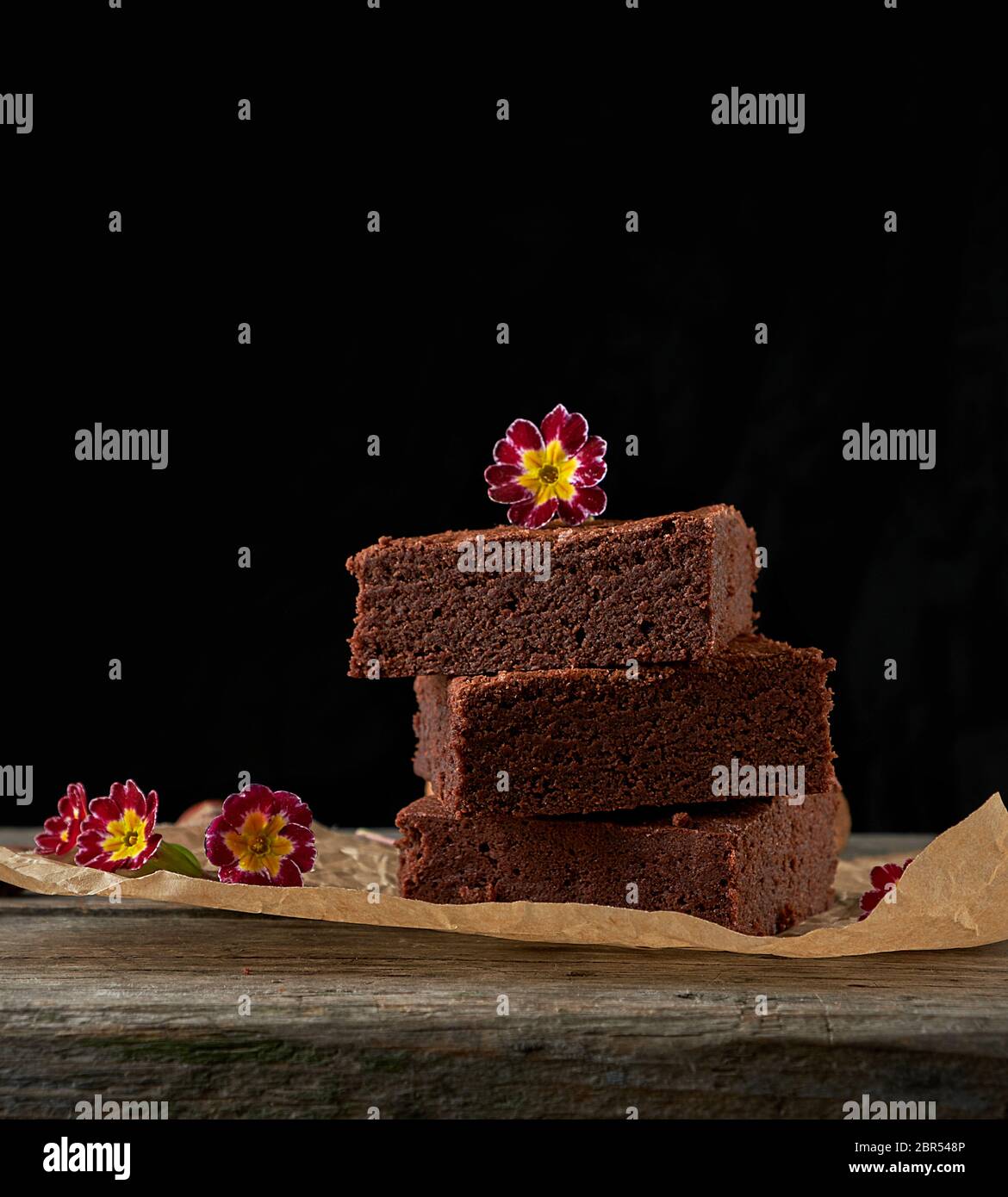 stack of baked square pieces of chocolate brownie cake on brown ...