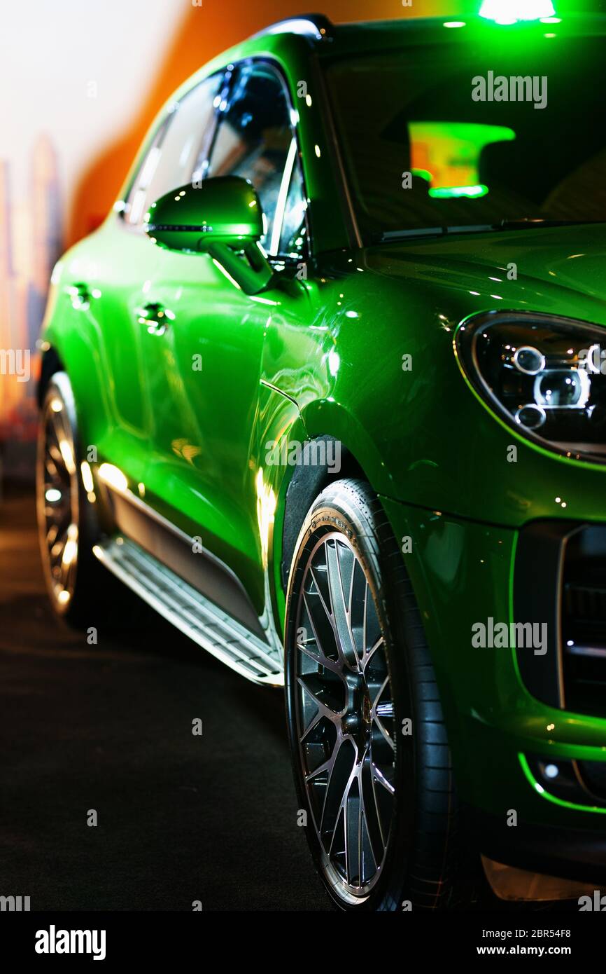 Green car on the street of a big city Stock Photo - Alamy