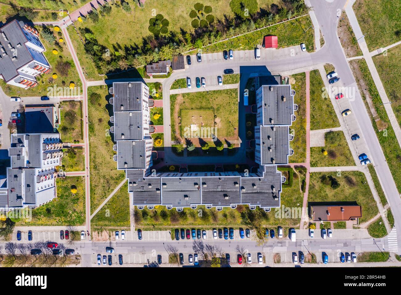 Aerial city view with crossroads and roads, houses, buildings, parks ...
