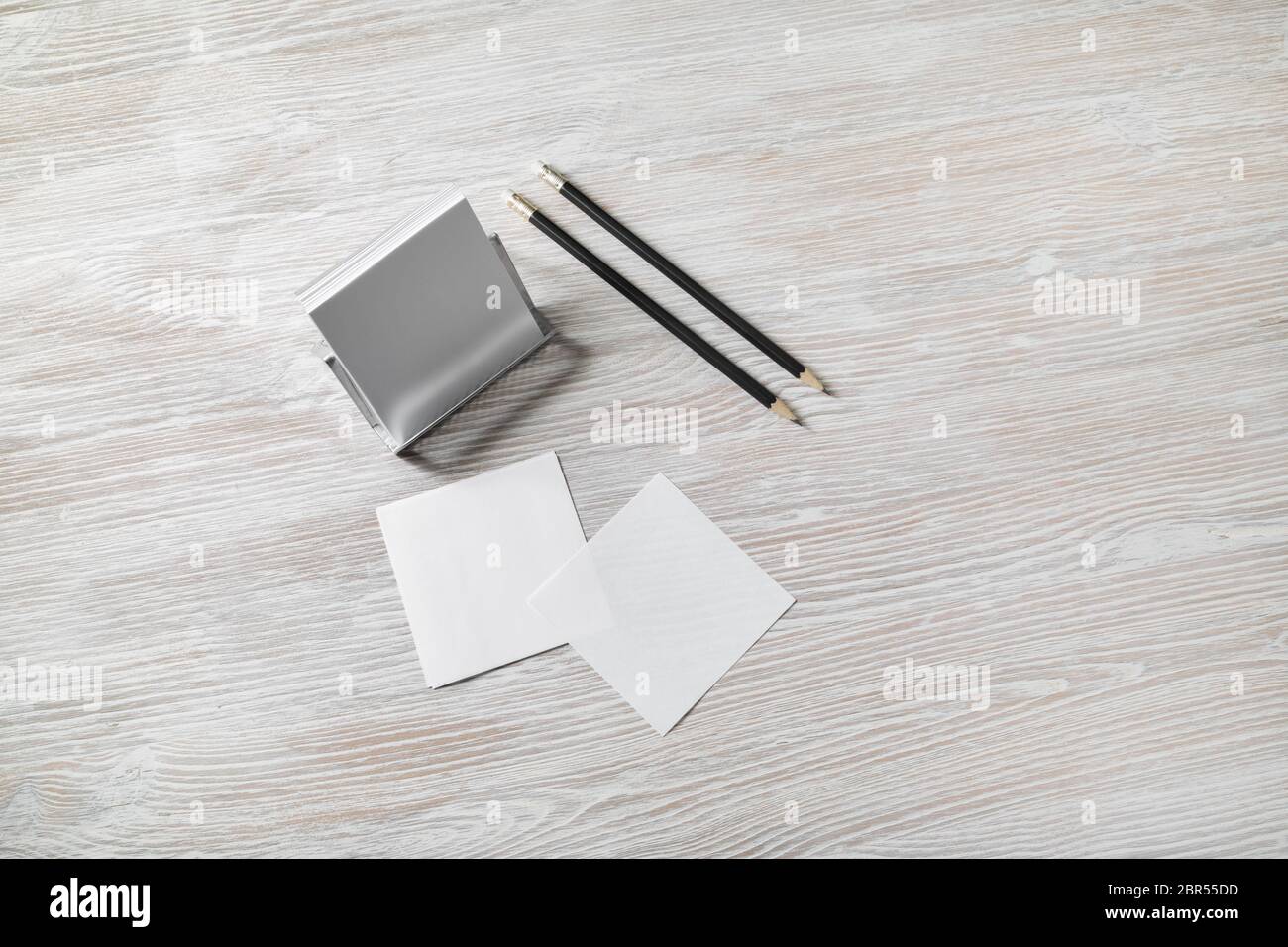 Blank notes and pencils on light wooden background. Blank stationery ...