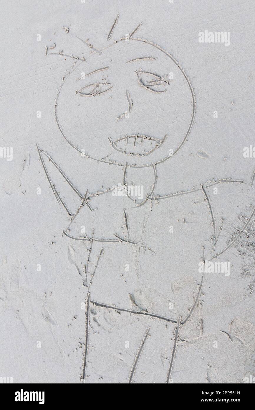 Drawing on sand on a theme of rest,Shaped like a man Stock Photo - Alamy