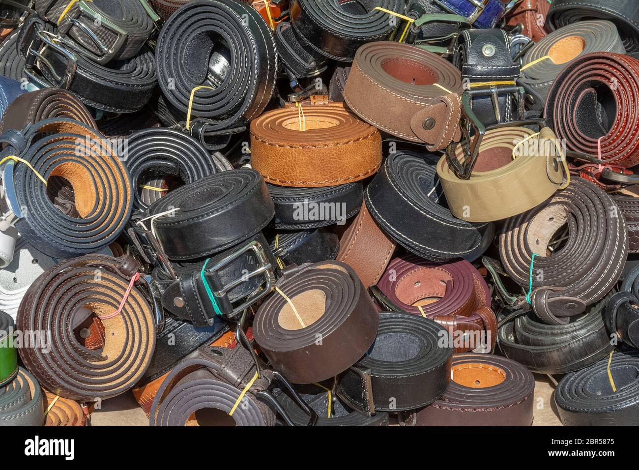 full frame background showing lots of various rolled belts Stock Photo ...