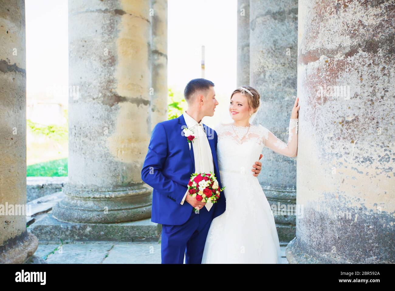 bride and groom pain large columns. wedding Stock Photo - Alamy