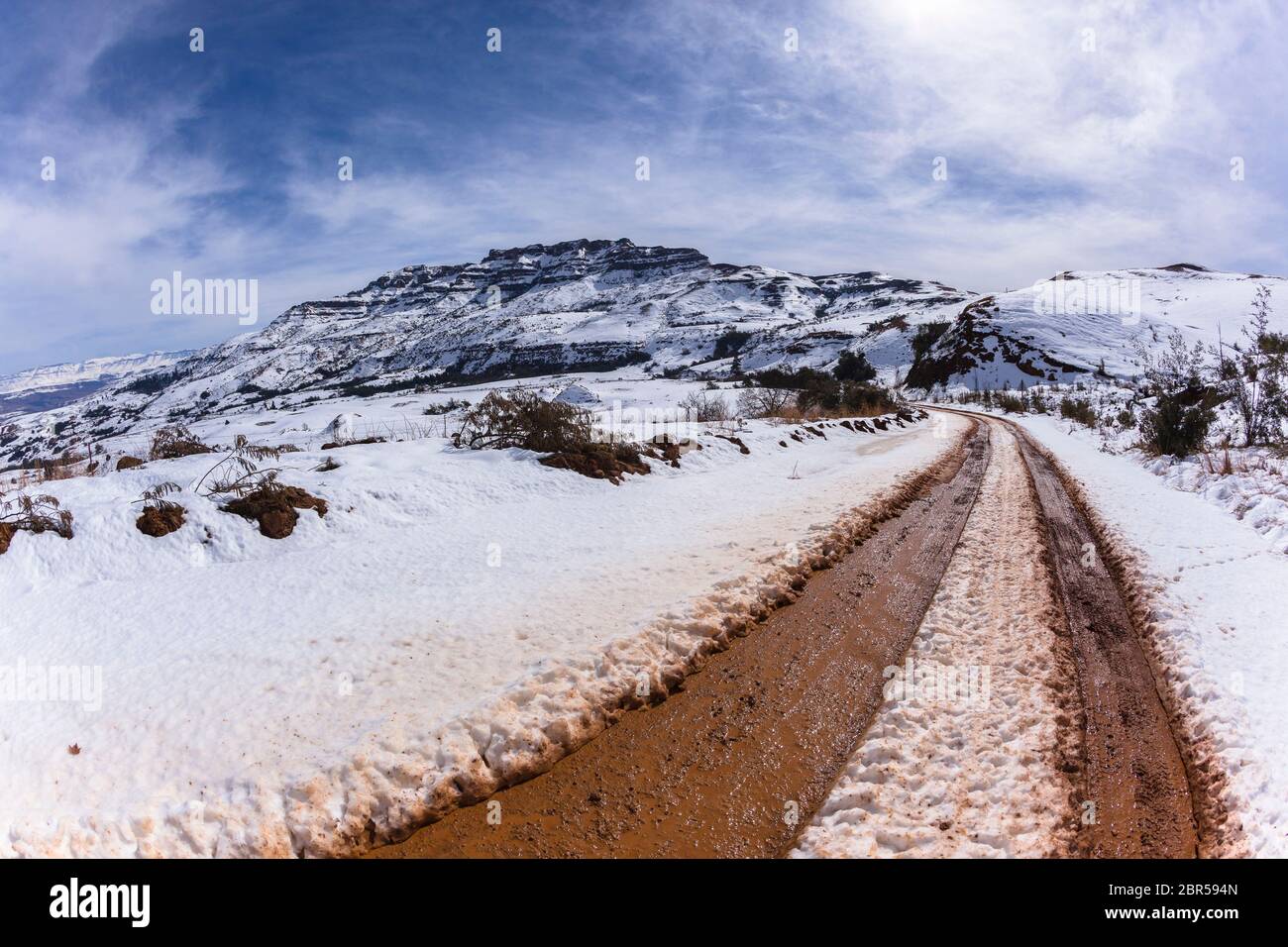 Mountains Snow dirt road tracks towards hilltop Stock Photo - Alamy