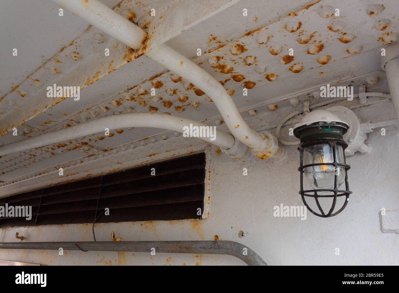 Rust bleeding through white paint on a boat interior, vintage light ...
