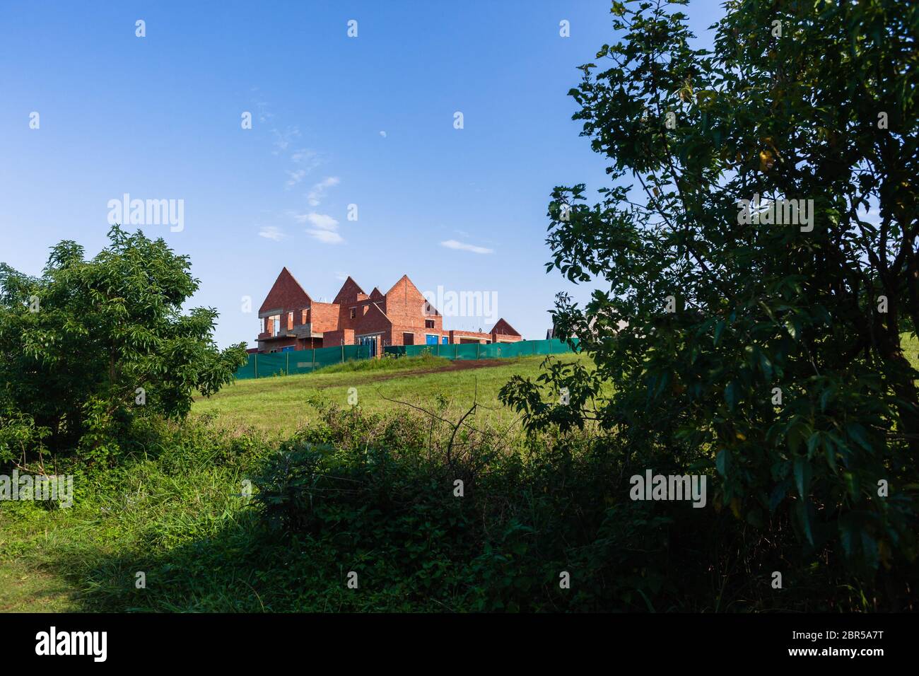 Home building construction halfway brickwork block structure in blue ...