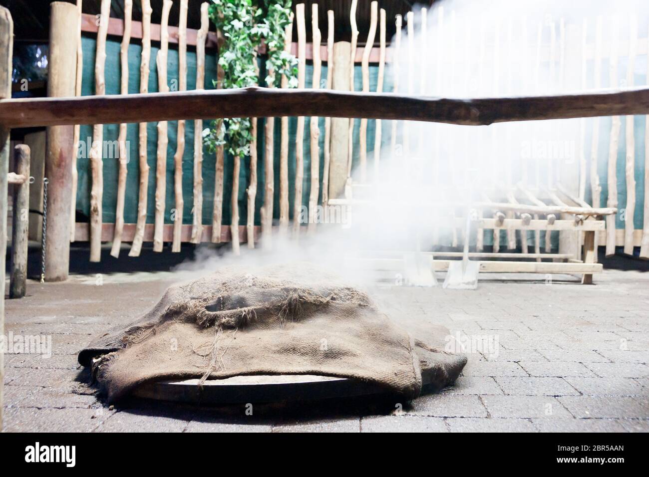 Smoke and dust fly as food is being prepared for a traditional maori ...