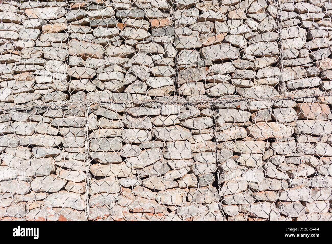 Stone wire cage wall constructed for retaining earth building ...