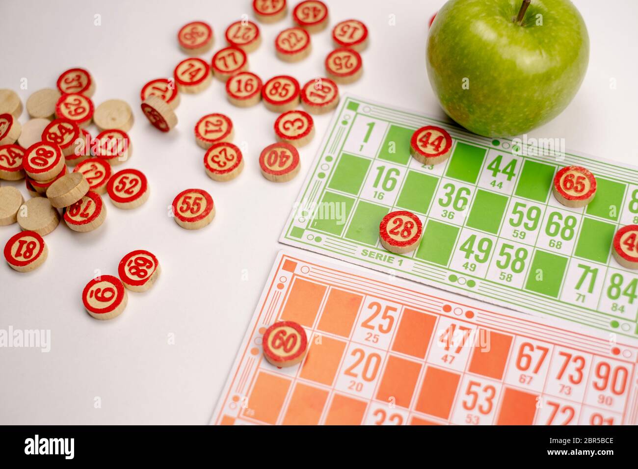 Wooden kegs, cards and chips for playing lotto on a white background ...