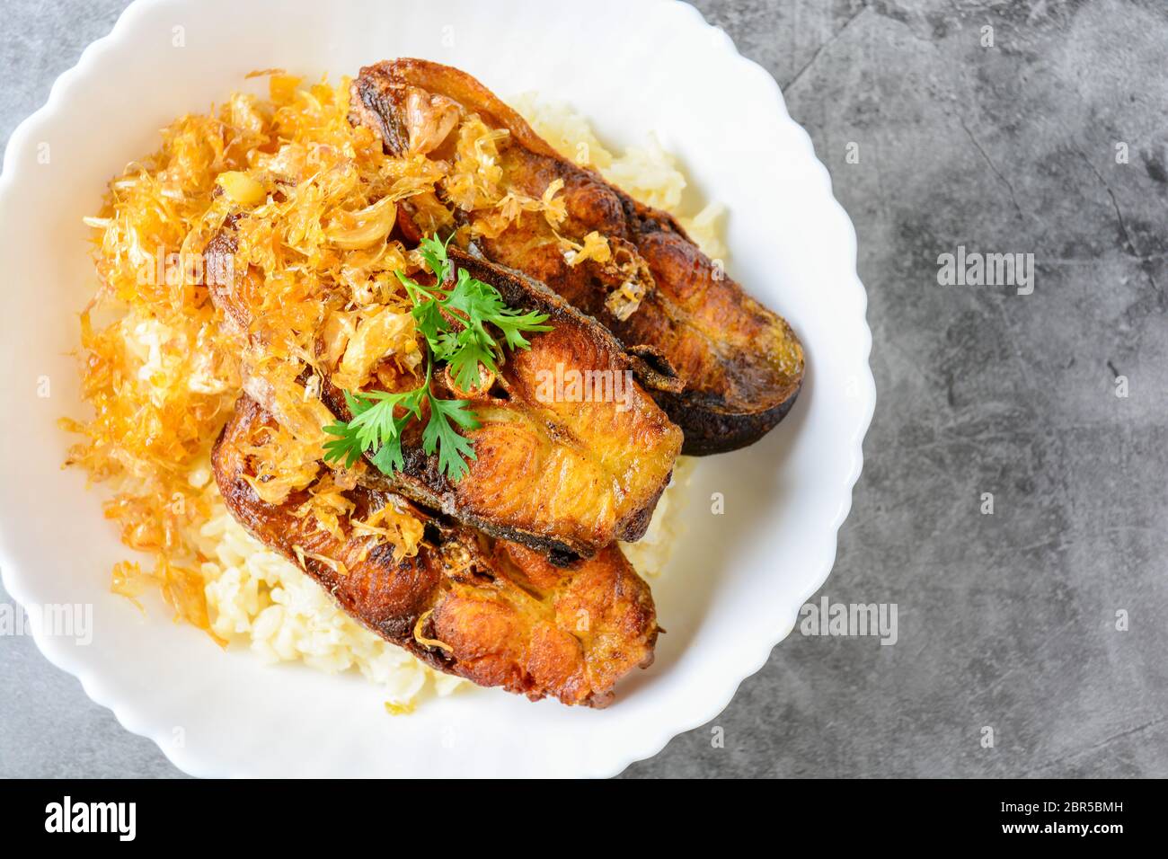Deep fried sliced Pangasius fish with garlic, served with brown rice ...