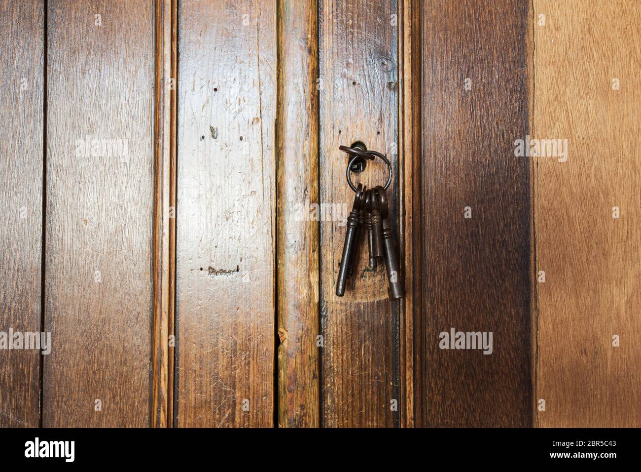 Old rusty keys inside a keyhole of an old antique closet. vintage ...