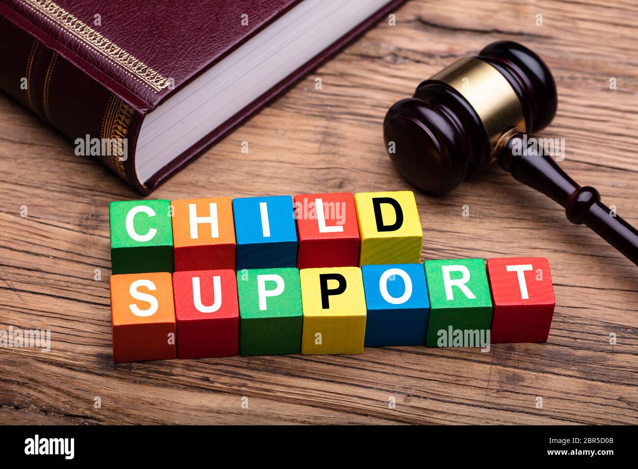 Child Support Colorful Block With Bible And Hammer Over Wooden Desk In ...