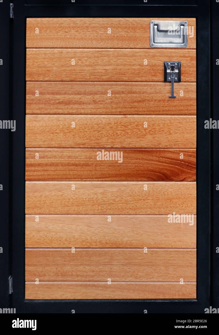 Closed locker inside wall interior with wooden door Stock Photo - Alamy