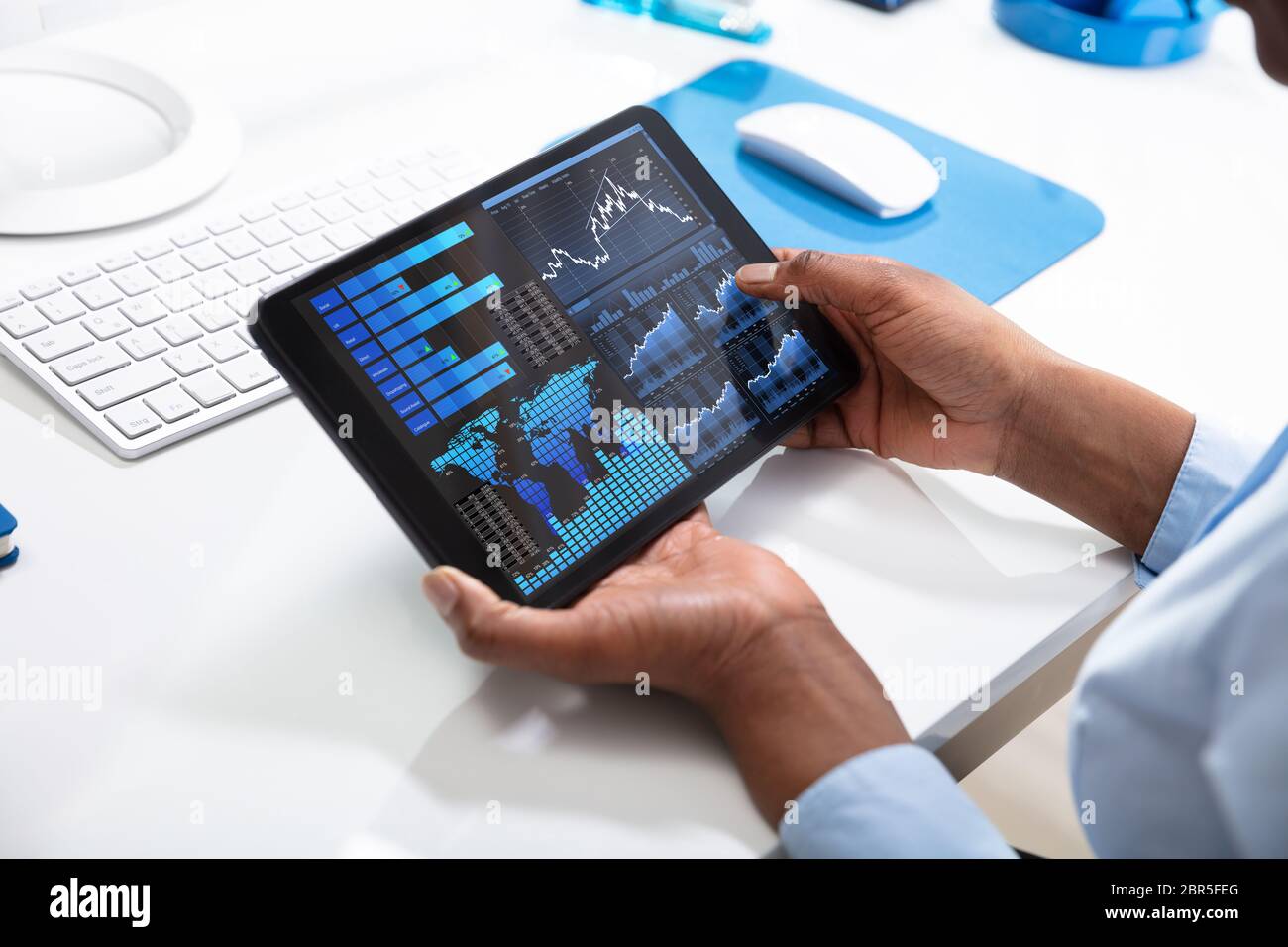 Businessperson's Hand Pointing On Tablet Screen Showing Graph Over The ...