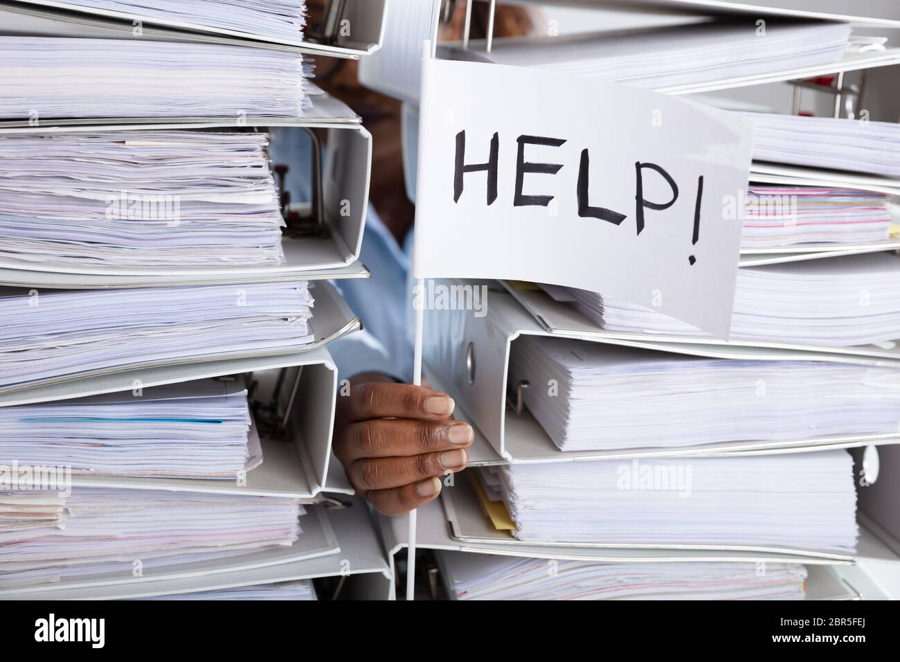 Businesswoman Holding White Help Flag With Stack Of Folders Stock Photo ...