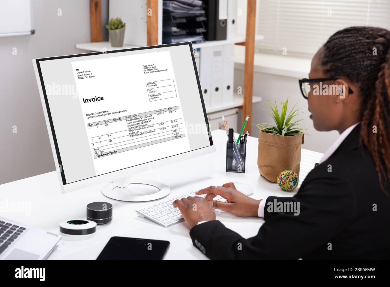 African female checking invoice hi-res stock photography and images - Alamy