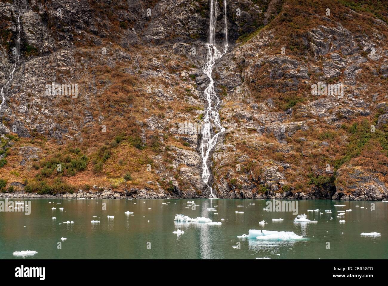 Melt water cascades down Mount Gilbert from Serpentine Glacier in Barry ...